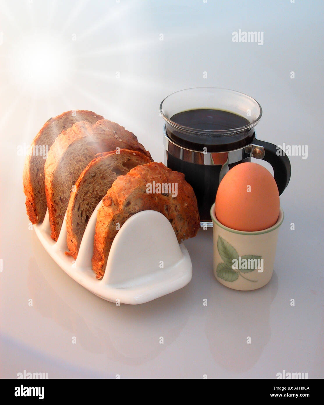 Traditional breakfast of brown toast boiled egg and coffee with morning ...