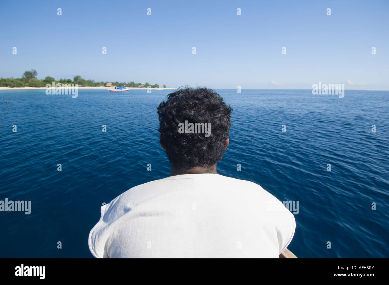 rear view of man on boat looking into the sea Stock Photo - Alamy