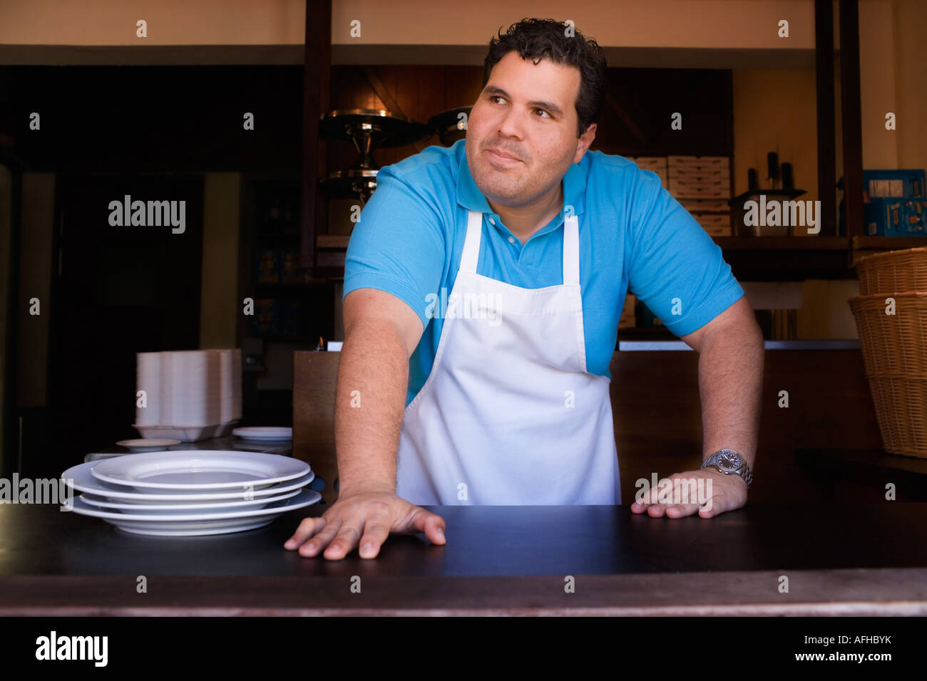 Portrait of chef behind restaurant counter Stock Photo - Alamy