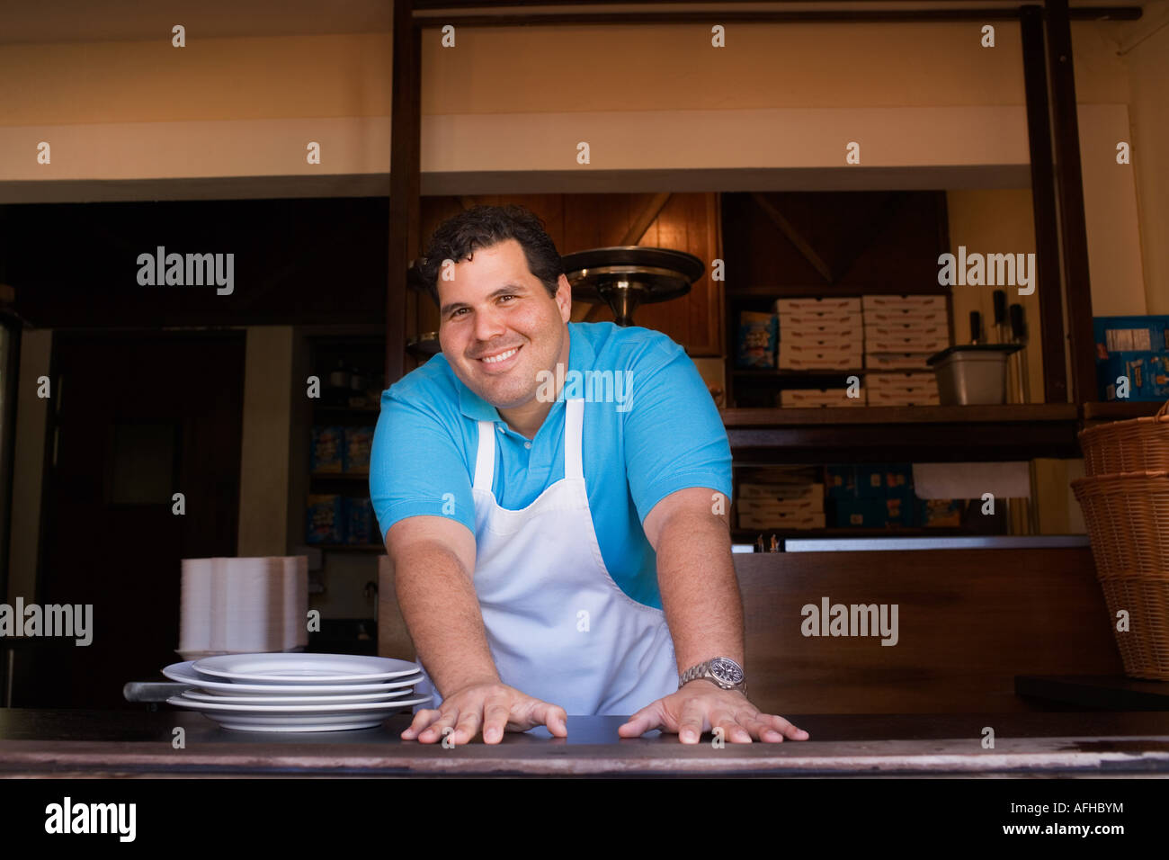 Portrait of chef behind restaurant counter Stock Photo - Alamy