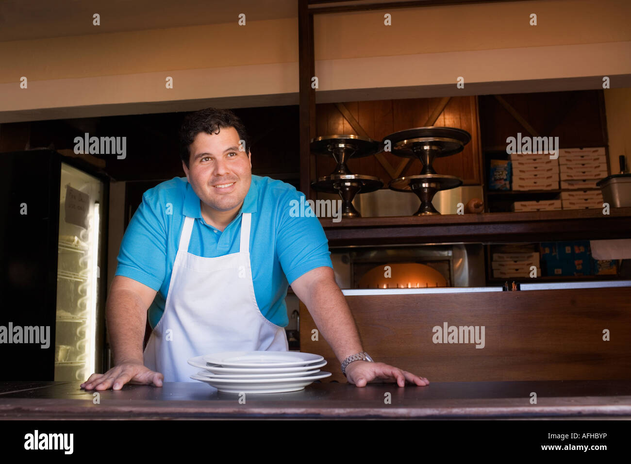 Portrait of chef behind restaurant counter Stock Photo - Alamy