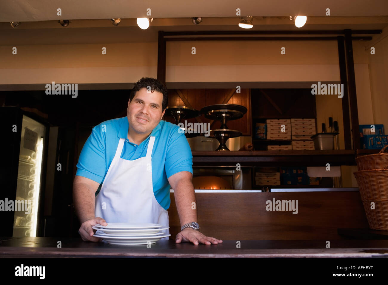Portrait of chef behind restaurant counter Stock Photo - Alamy