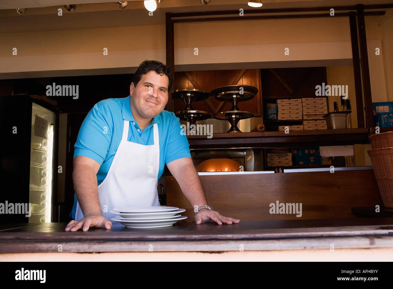 Portrait of chef behind restaurant counter Stock Photo - Alamy