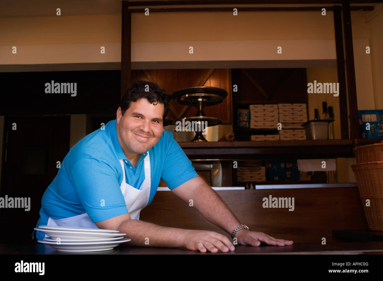Portrait of chef behind restaurant counter Stock Photo - Alamy