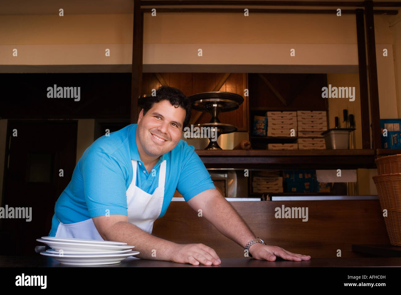 Portrait of chef behind restaurant counter Stock Photo - Alamy