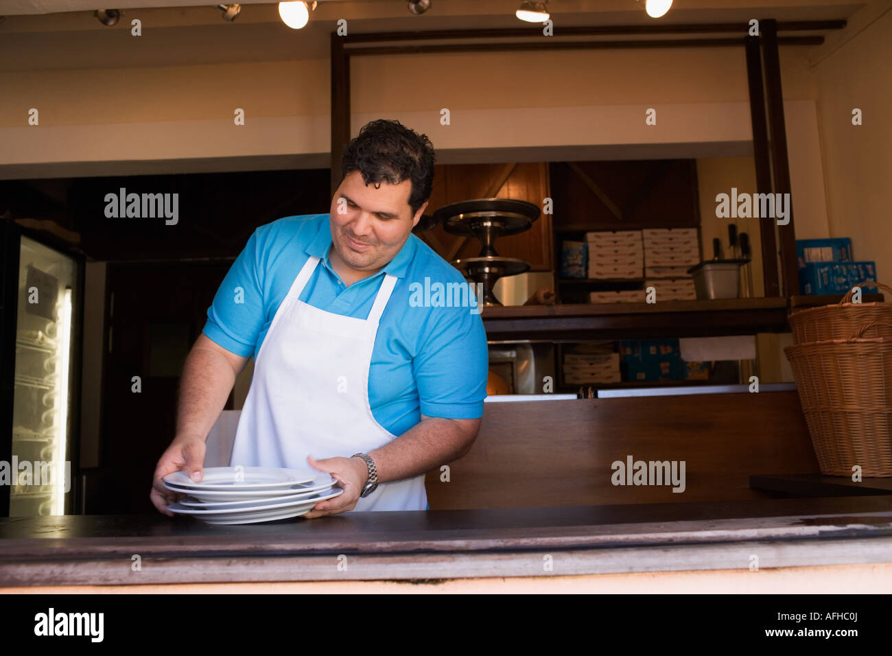 Portrait of chef behind restaurant counter Stock Photo - Alamy