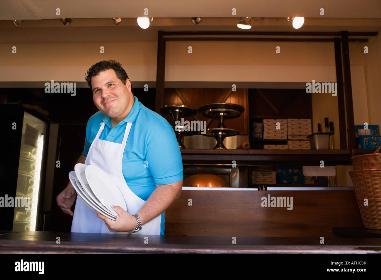 Portrait of chef behind restaurant counter Stock Photo - Alamy