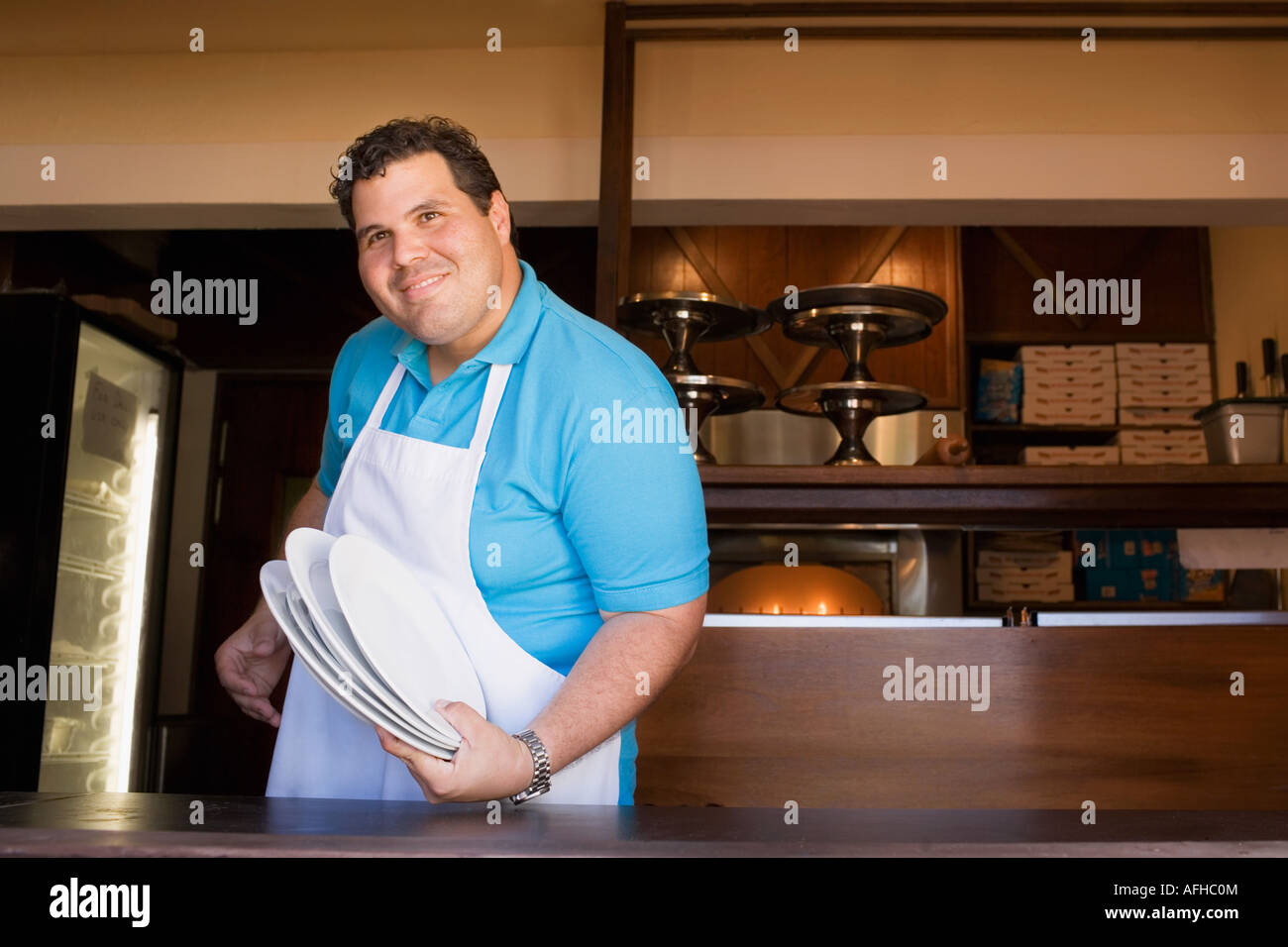 Portrait of chef behind restaurant counter Stock Photo - Alamy