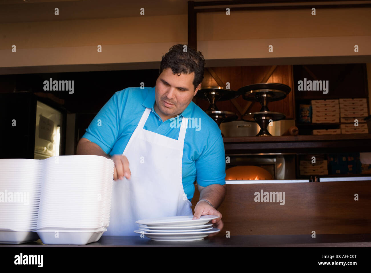 Portrait of chef behind restaurant counter Stock Photo - Alamy