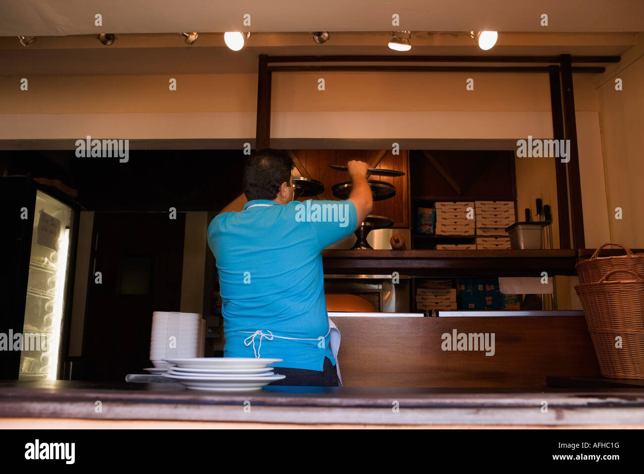 Portrait of chef behind restaurant counter Stock Photo - Alamy
