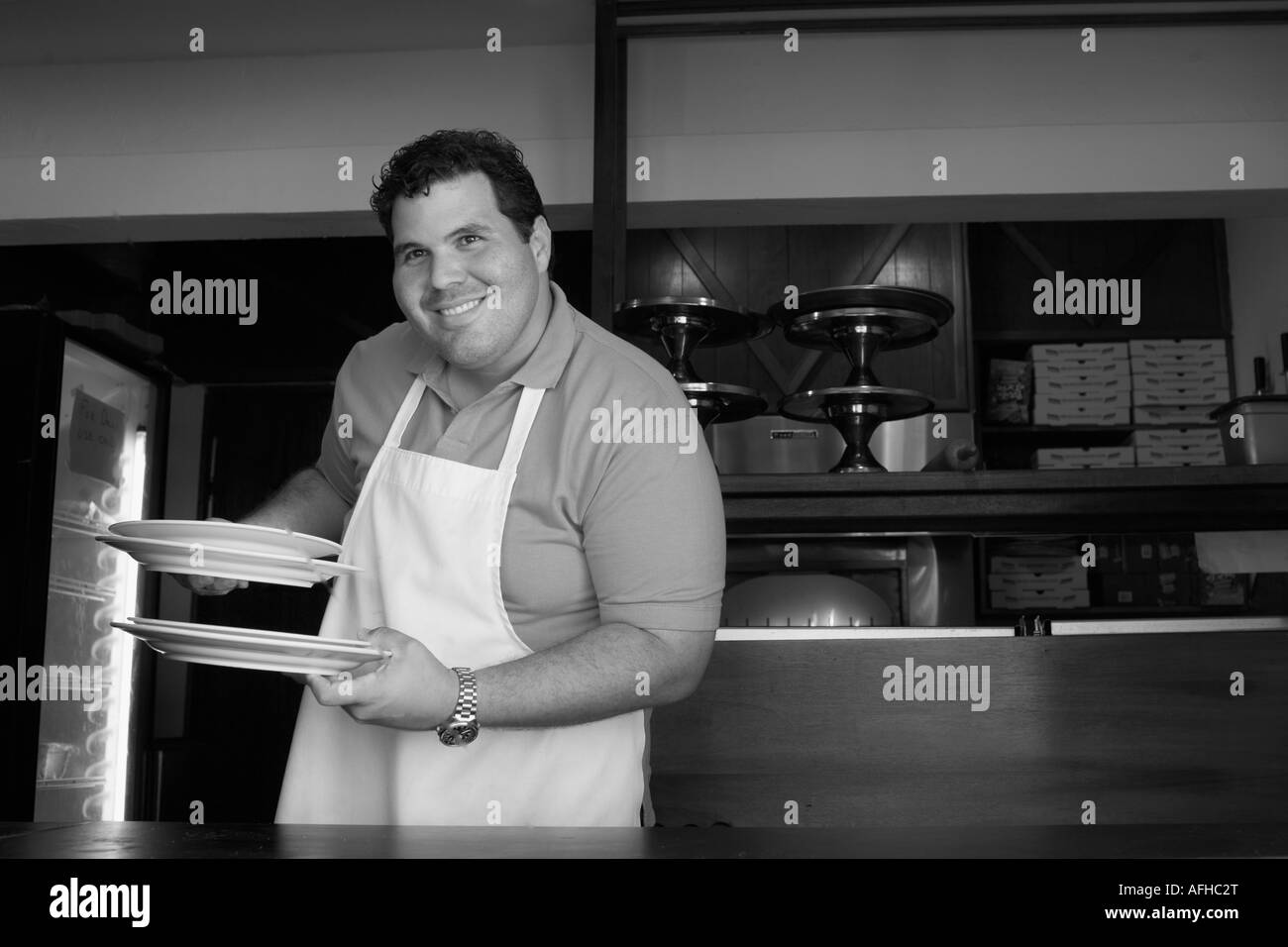 Portrait of chef behind restaurant counter Stock Photo - Alamy