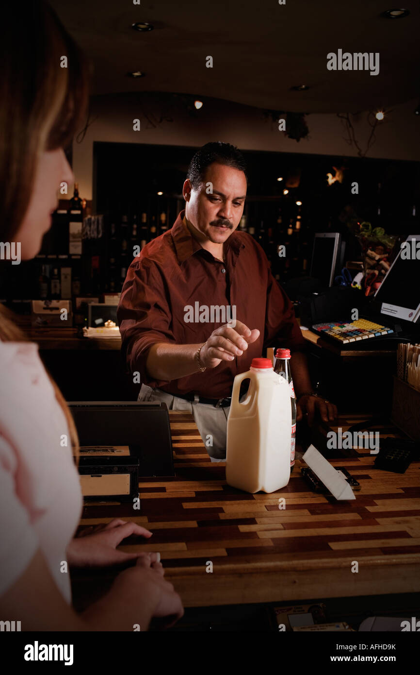 Business owner checking customers groceries Stock Photo - Alamy
