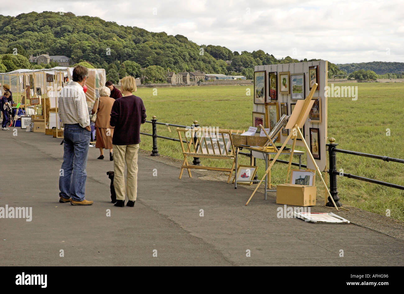 Artists exhibiting and selling their work at an outdoor exhibition on a ...