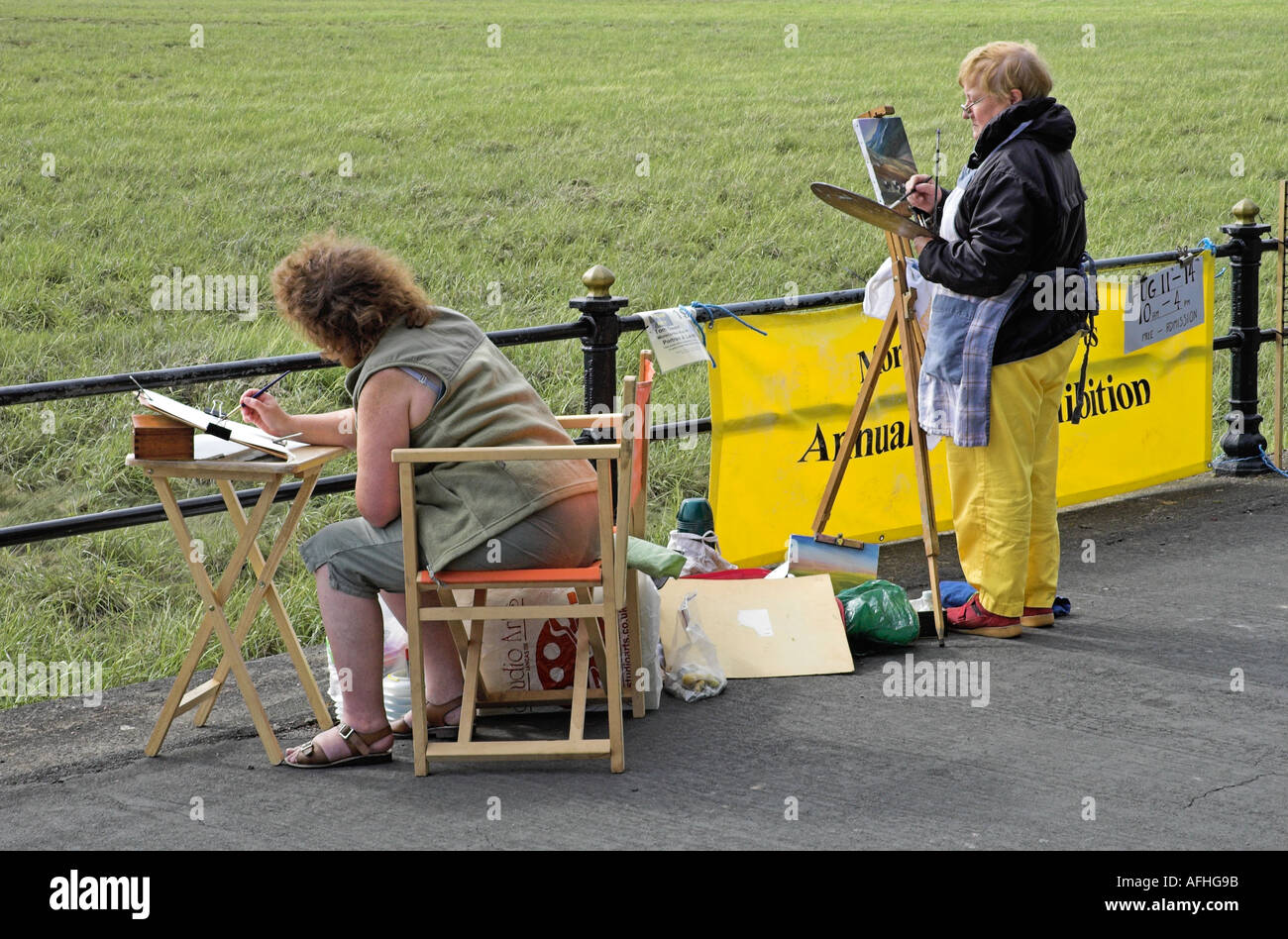 Artists painting exhibiting and selling their work at an outdoor ...