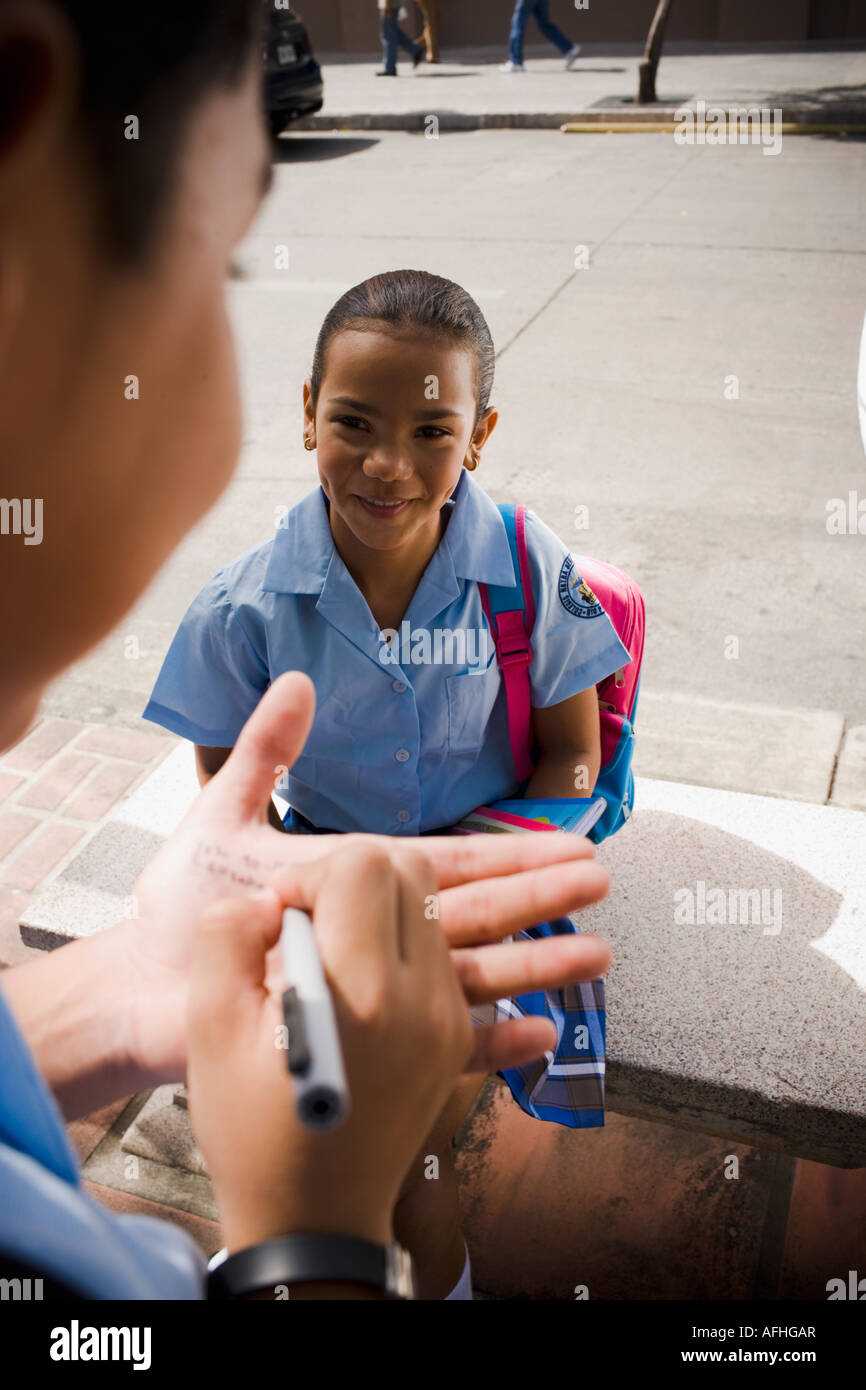 School girl giving phone number to boy Stock Photo - Alamy