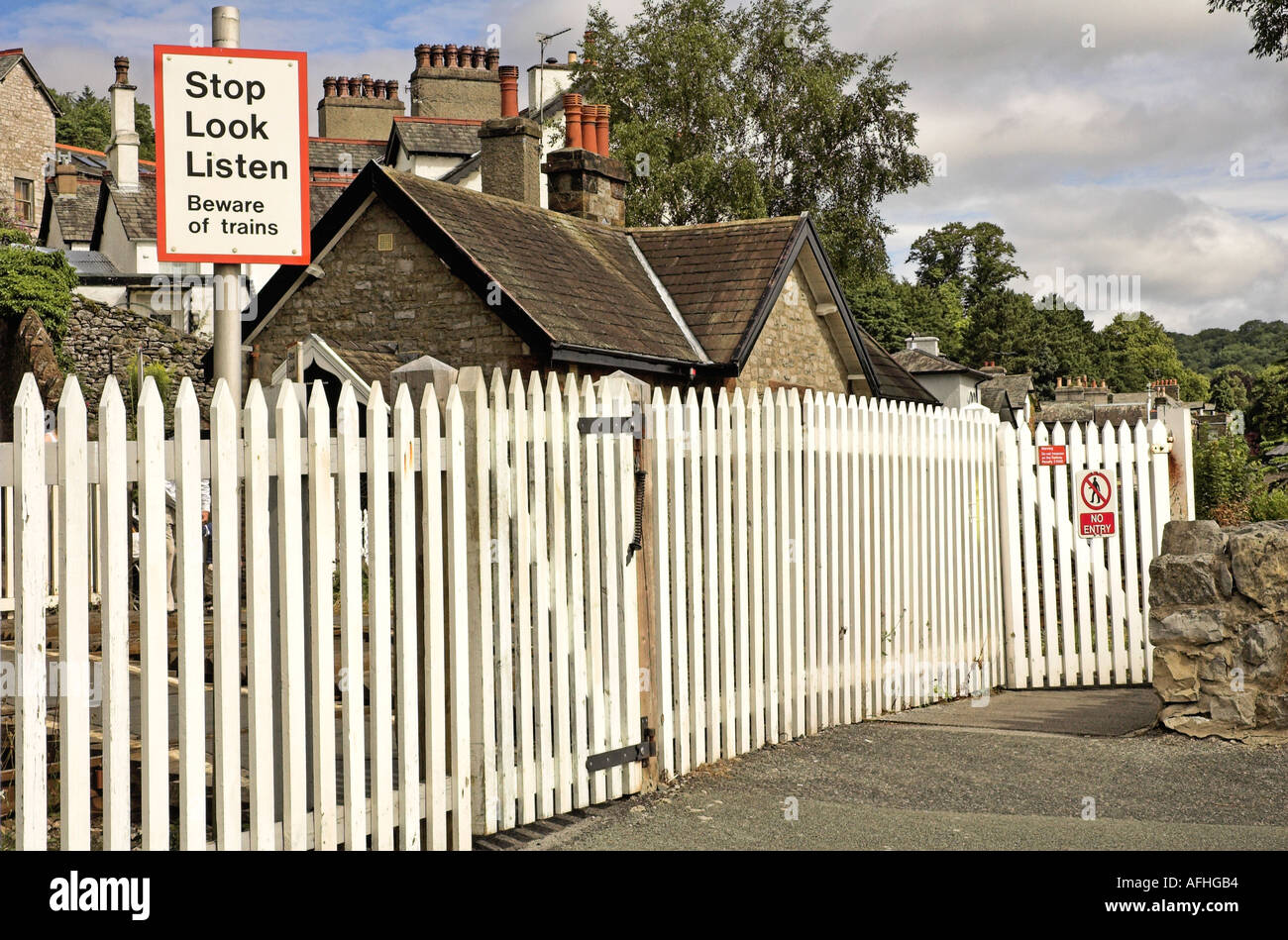 Gates to a pedestrian railroad or railway crossing with a warning sign ...