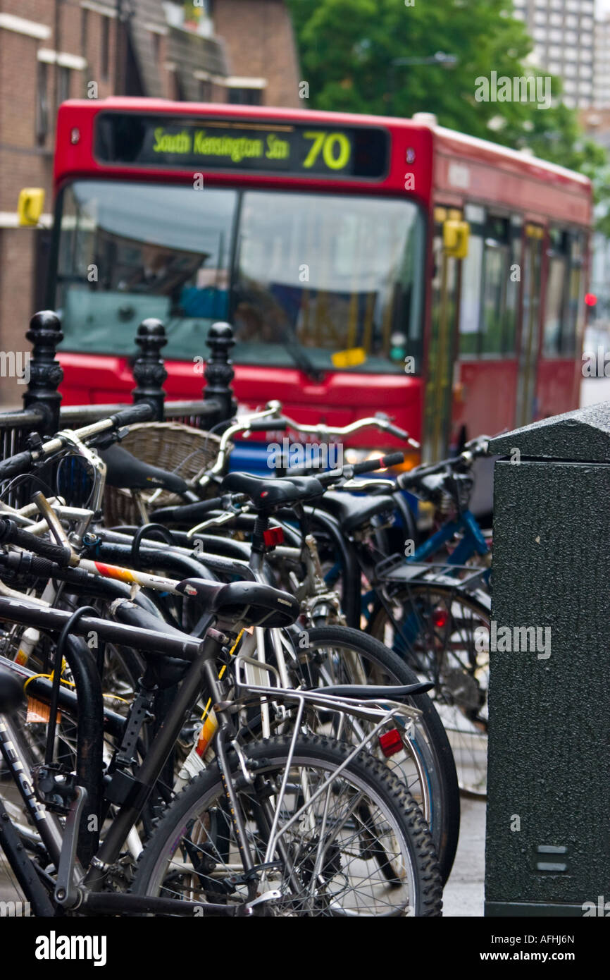 Bicycles parked the street as a red bus approaches London England UK Stock Photo - Alamy