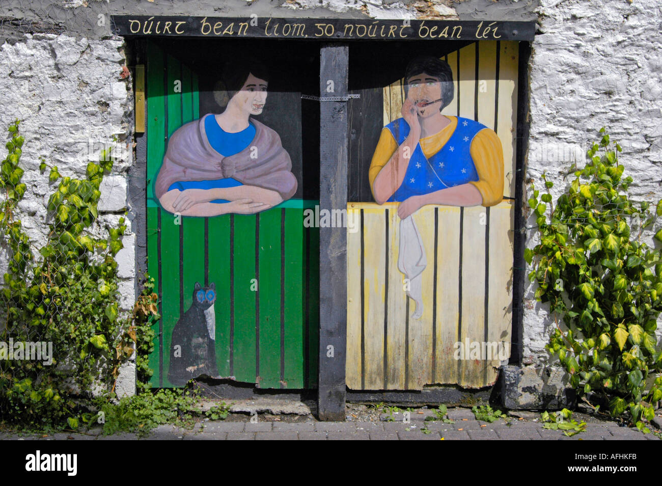Murals decorating disused buildings in a side alley in the centre or ...