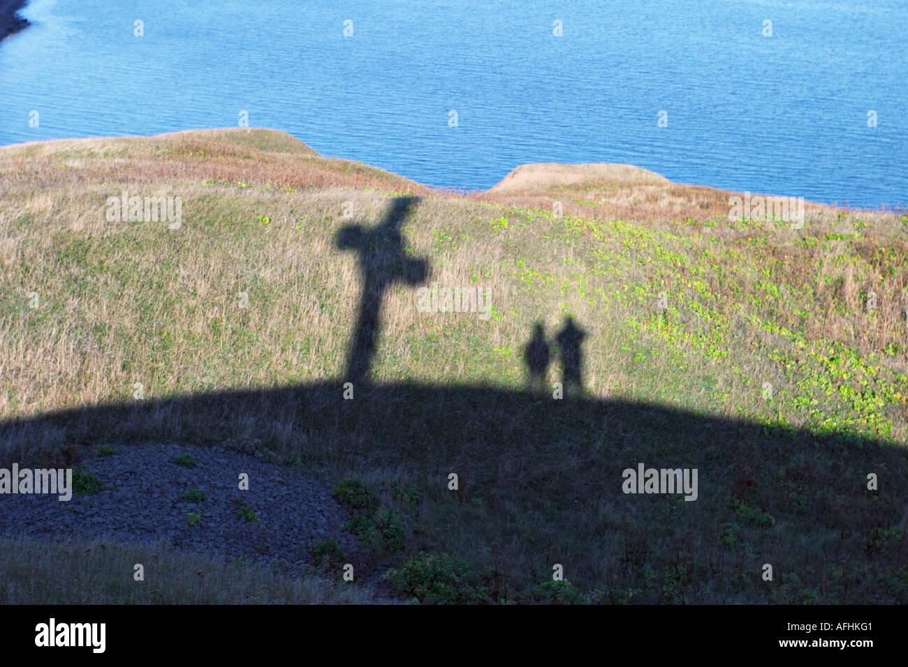 Shadow of two people and cross Stock Photo - Alamy