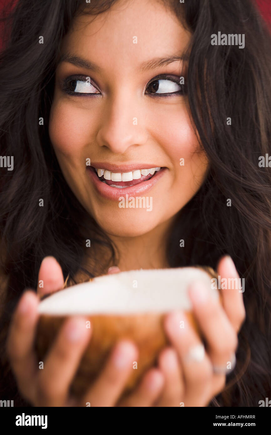 Young woman holding coconut Stock Photo - Alamy