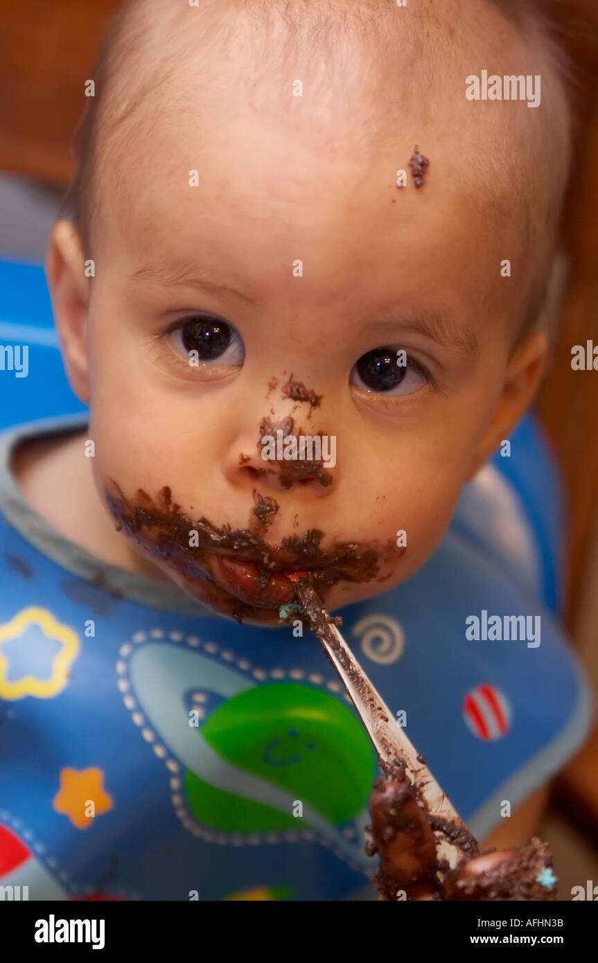 Messy face baby eating cake Stock Photo - Alamy