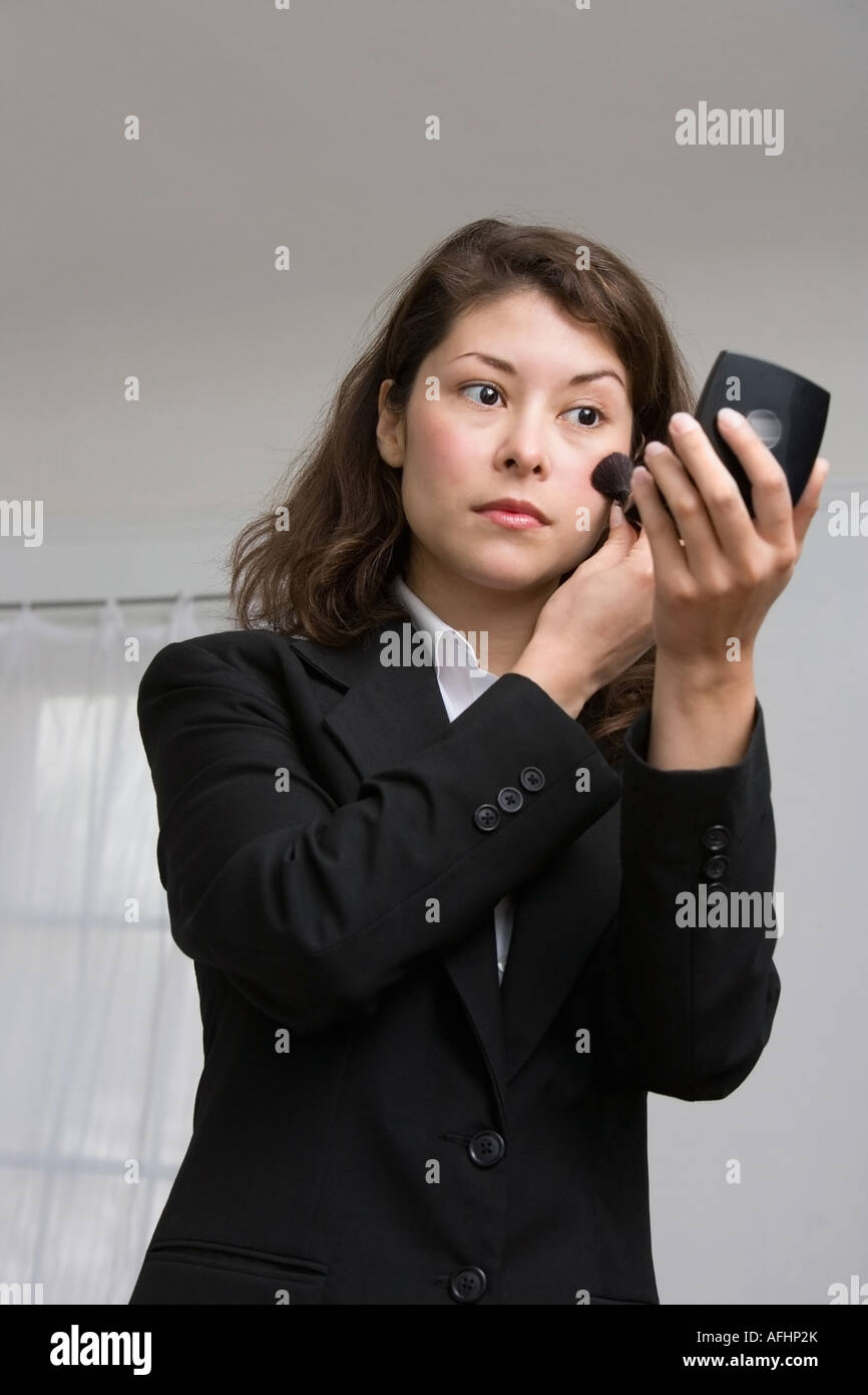 Young woman applying makeup Stock Photo - Alamy