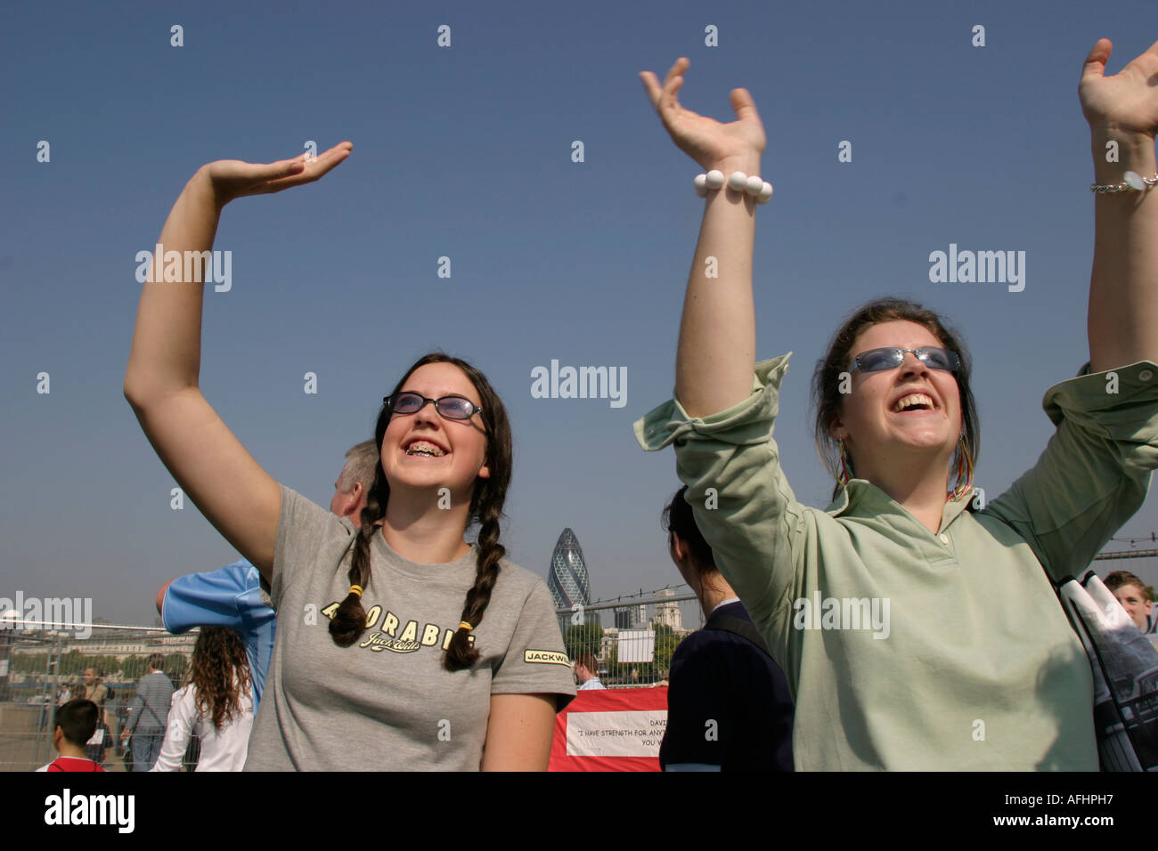 London Two young women waving on London's south bank at David Blaine ...