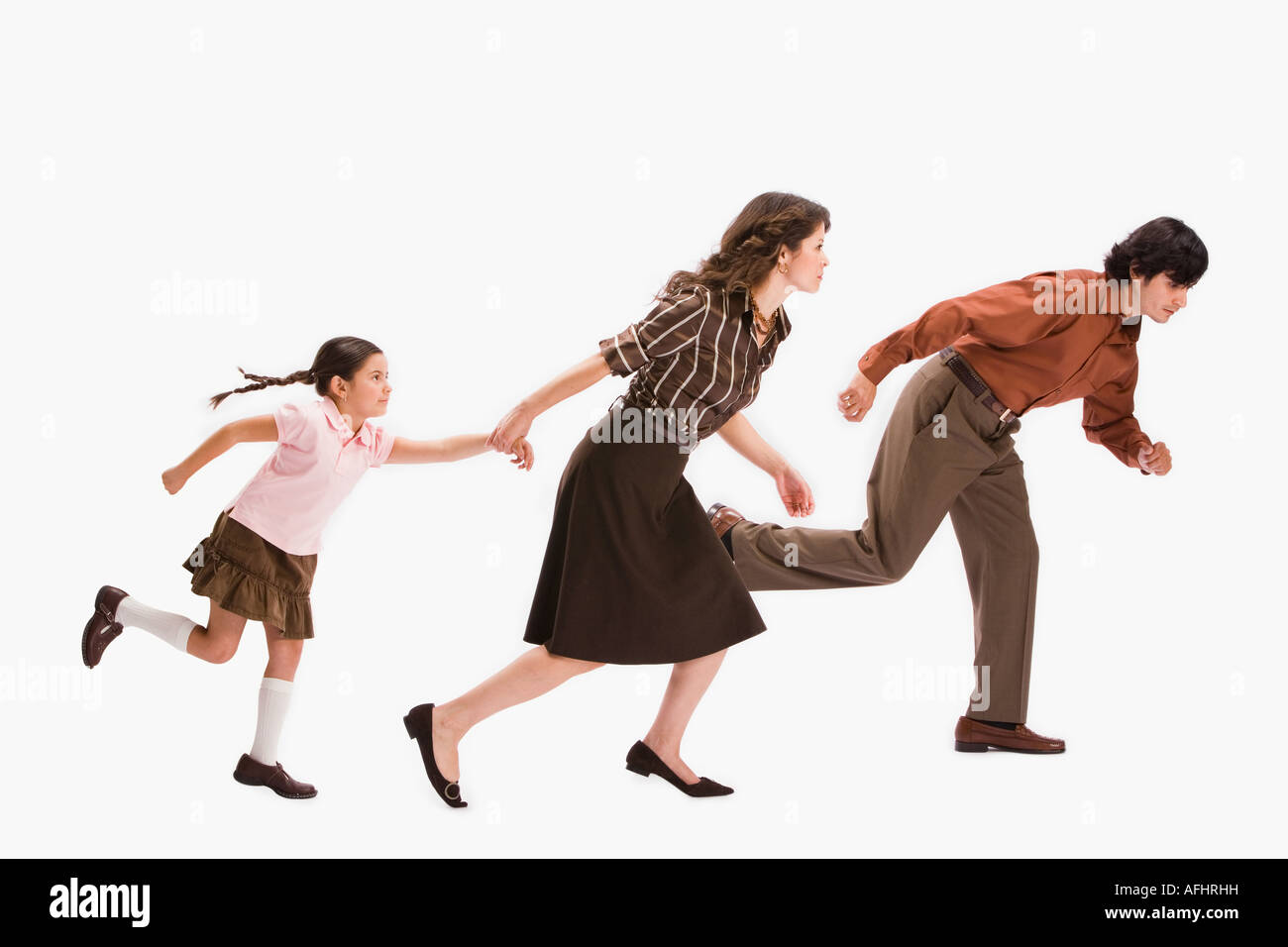 Studio portrait of family running Stock Photo - Alamy