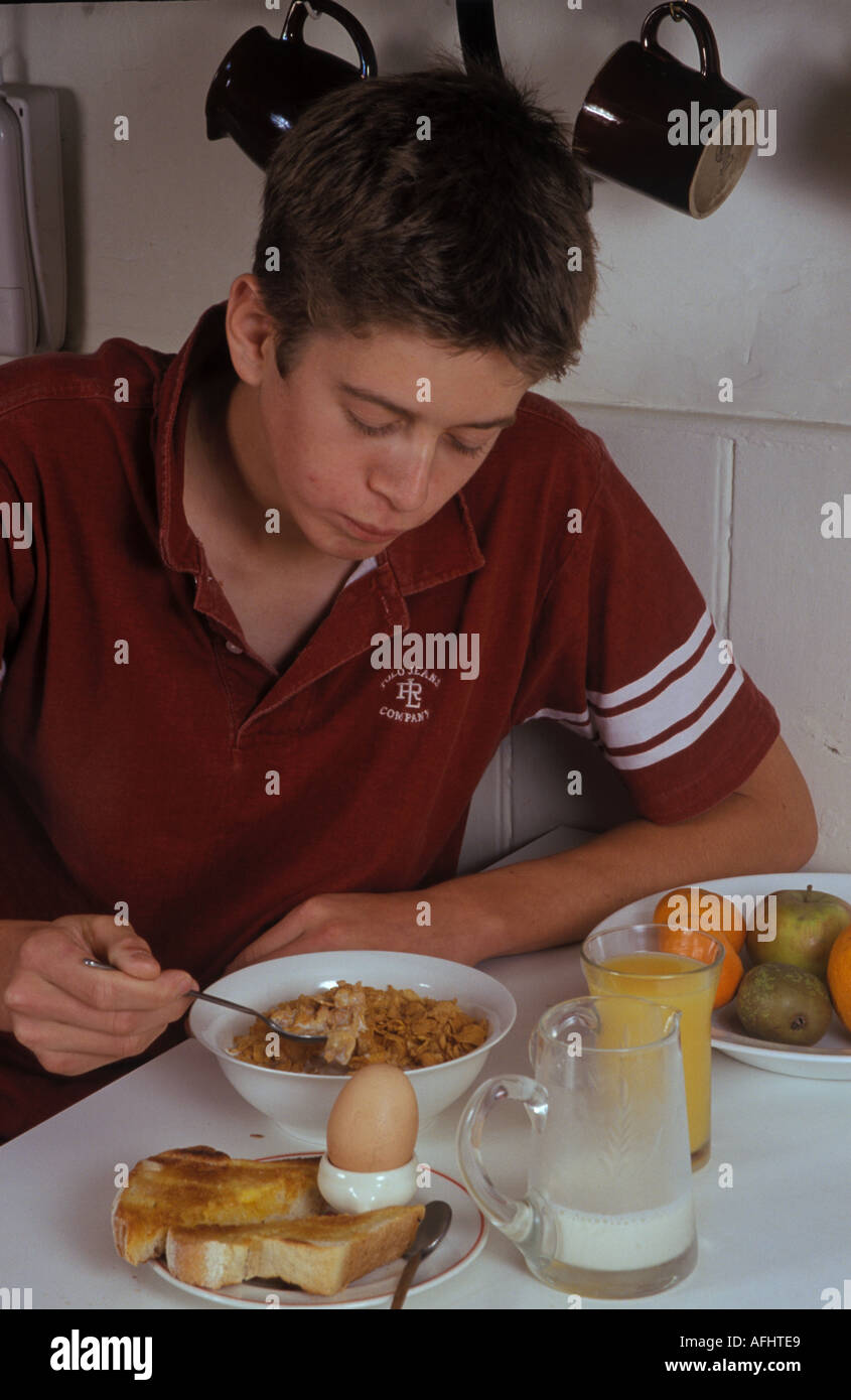 teenage boy eating cereal for breakfast Stock Photo - Alamy