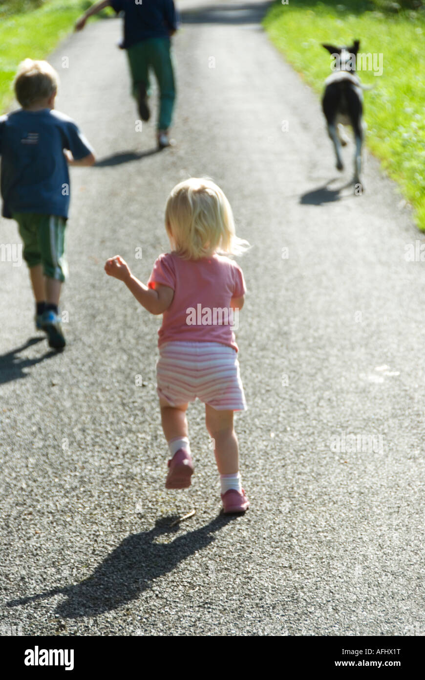 Image of children running down a country lane Stock Photo - Alamy