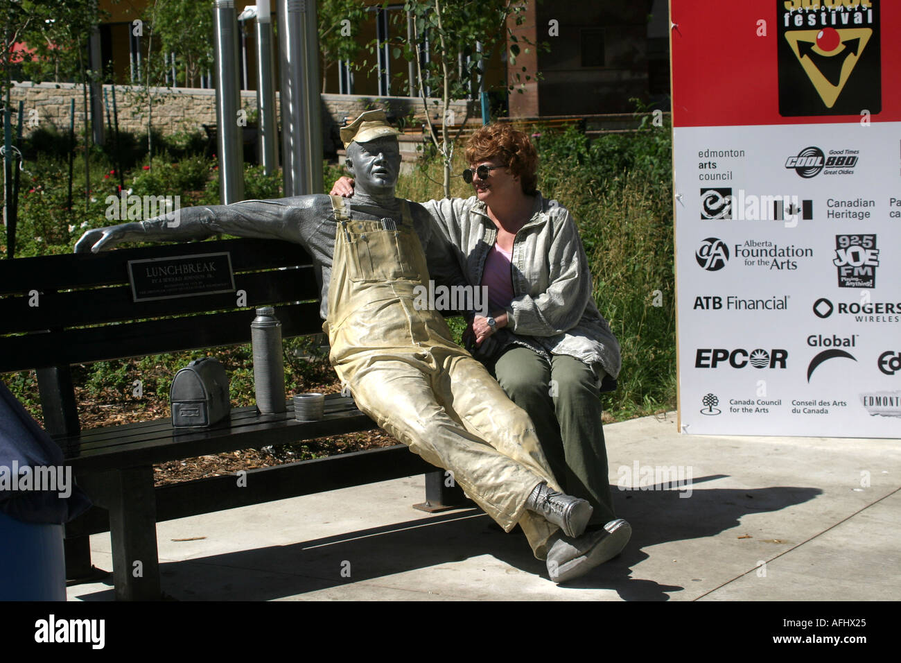 WOMAN EMBRACING A SEATED STATUE Stock Photo - Alamy