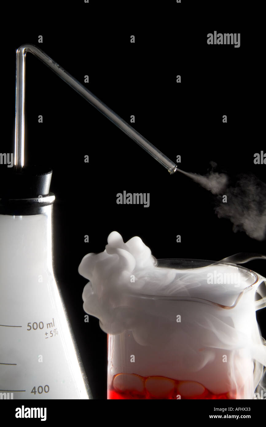 Laboratory flask and beaker with smoke and boiling liquid Stock Photo ...
