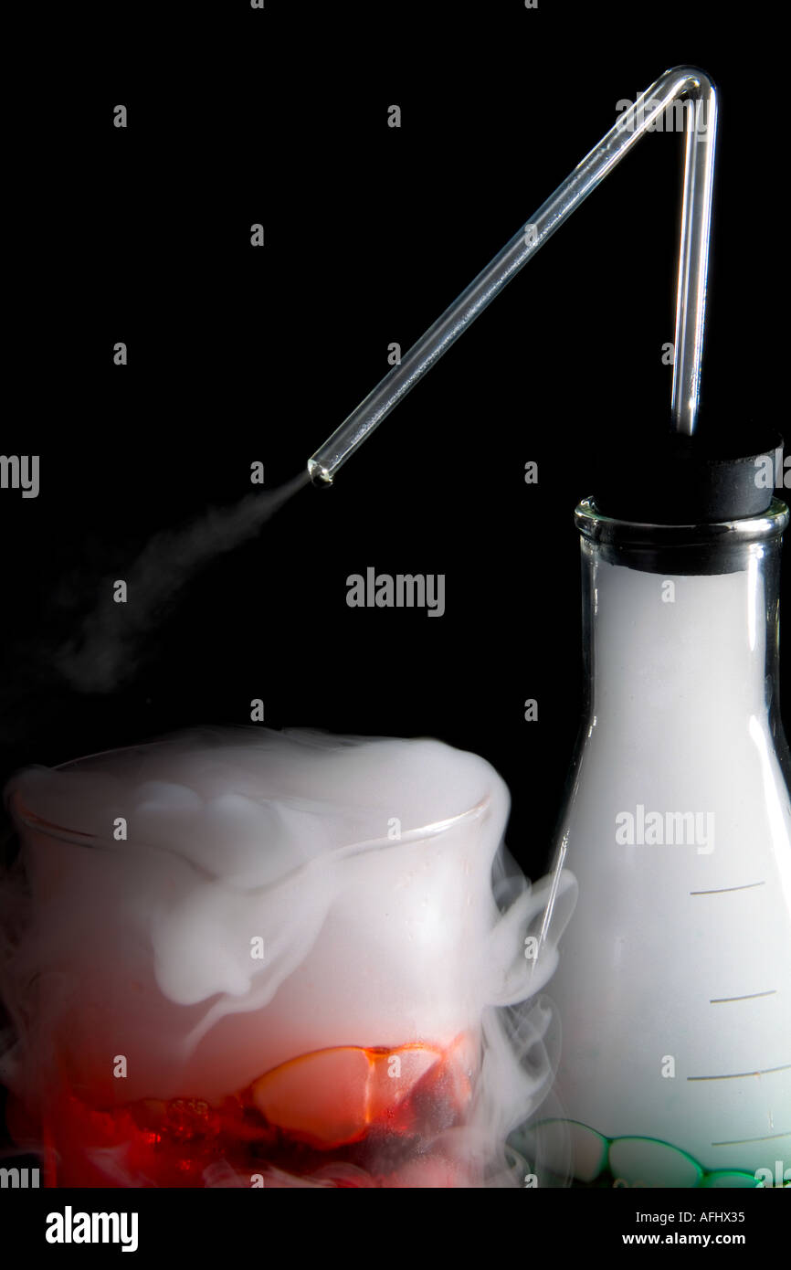 Laboratory flask and beaker with smoke and boiling liquid Stock Photo ...