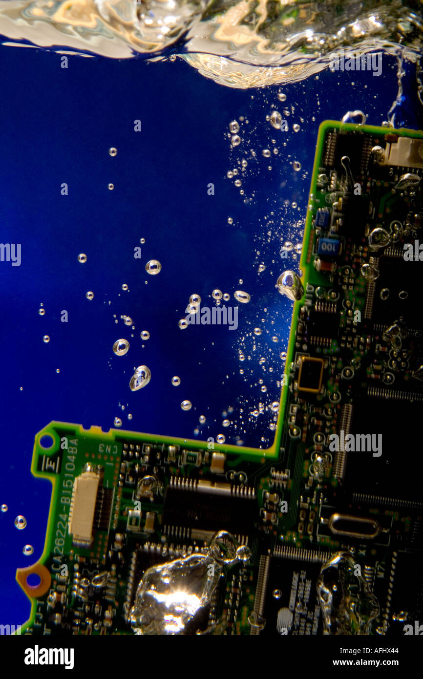 Computer circuit board splashing into blue water with bubbles Stock ...