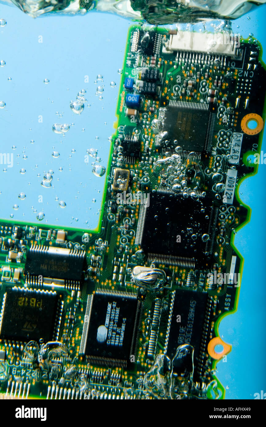 Computer circuit board splashing into blue water with bubbles Stock ...