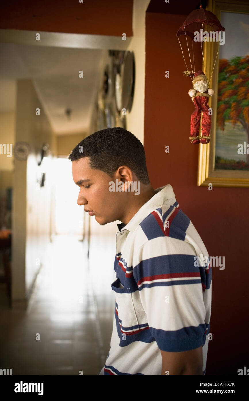 Young man looking down and thinking Stock Photo - Alamy