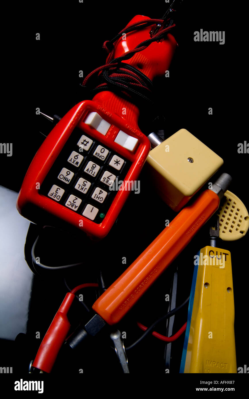 Pile of telephone repair tools on black background Stock Photo - Alamy