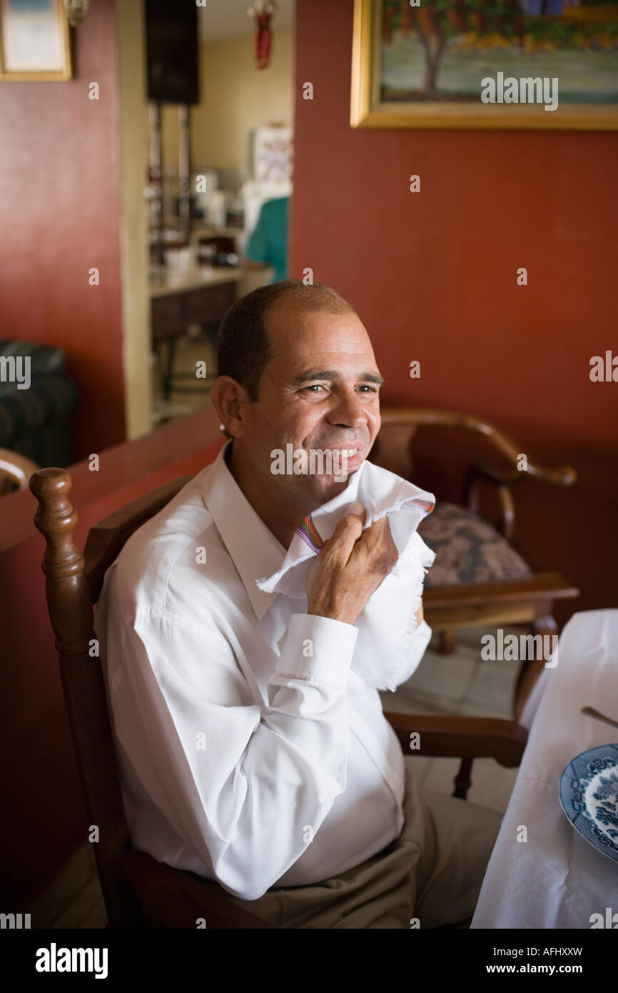 Mature man sitting at the dining table and smiling Stock Photo - Alamy