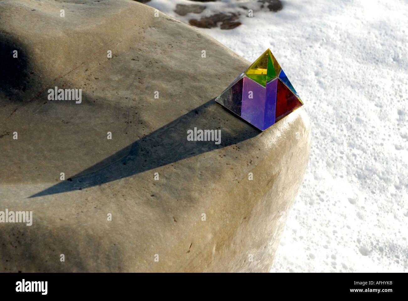 Glass pyramid prism light colour beach sand rock pebble sea seashore ...