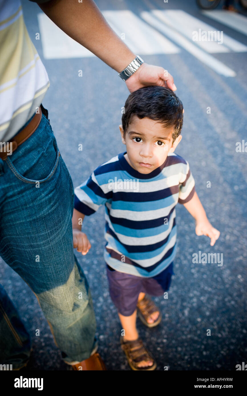 Portrait of a boy walking with his father Stock Photo - Alamy