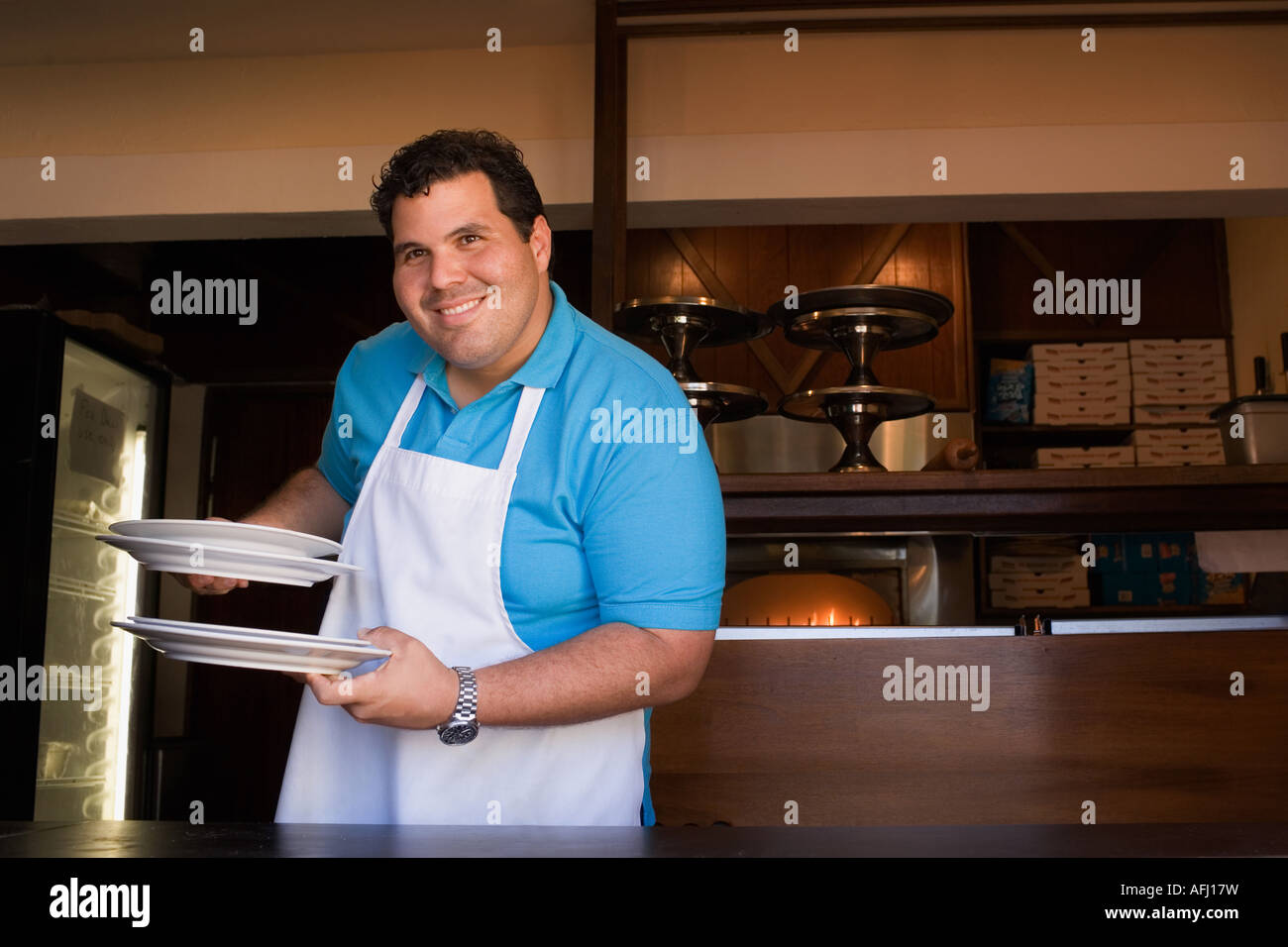 Portrait of chef behind restaurant counter Stock Photo - Alamy
