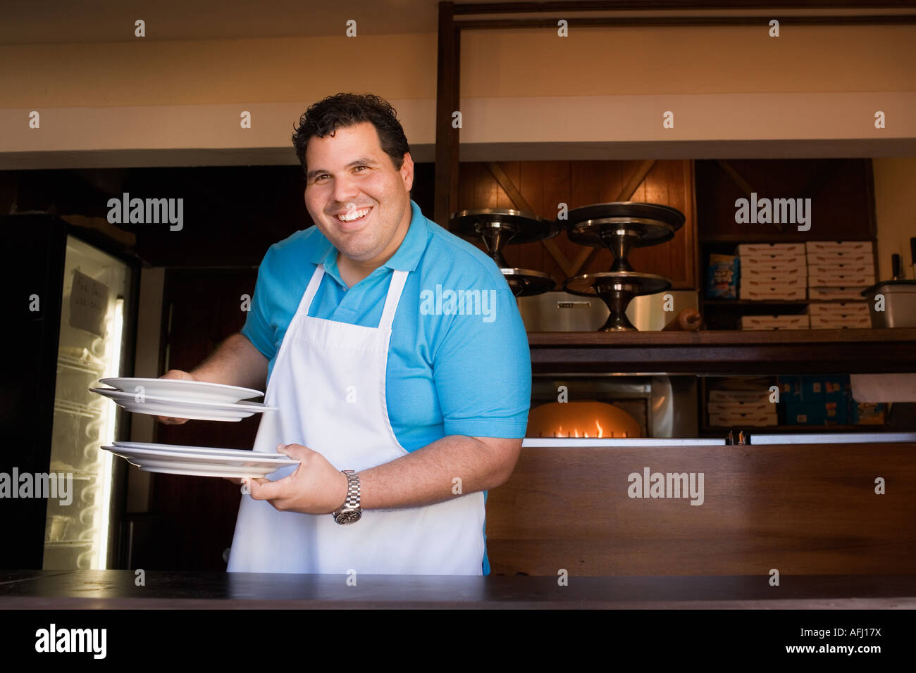 Portrait of chef behind restaurant counter Stock Photo - Alamy