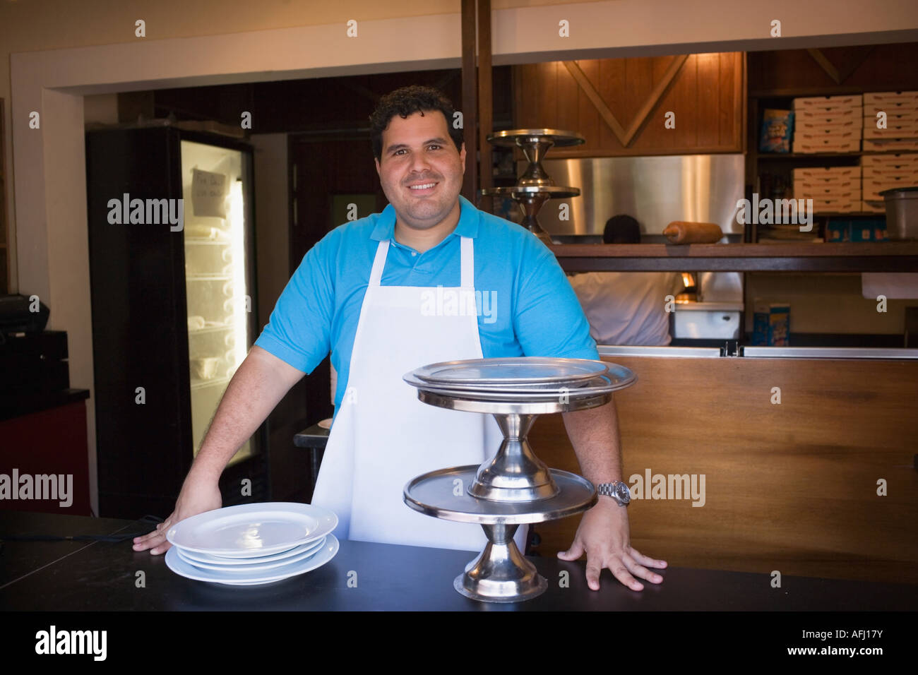 Portrait of chef behind restaurant counter Stock Photo - Alamy
