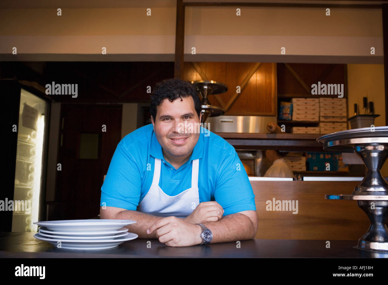 Portrait of chef behind restaurant counter Stock Photo - Alamy