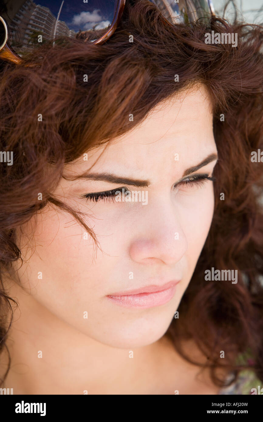 Brunette woman with sunglasses on head Stock Photo - Alamy
