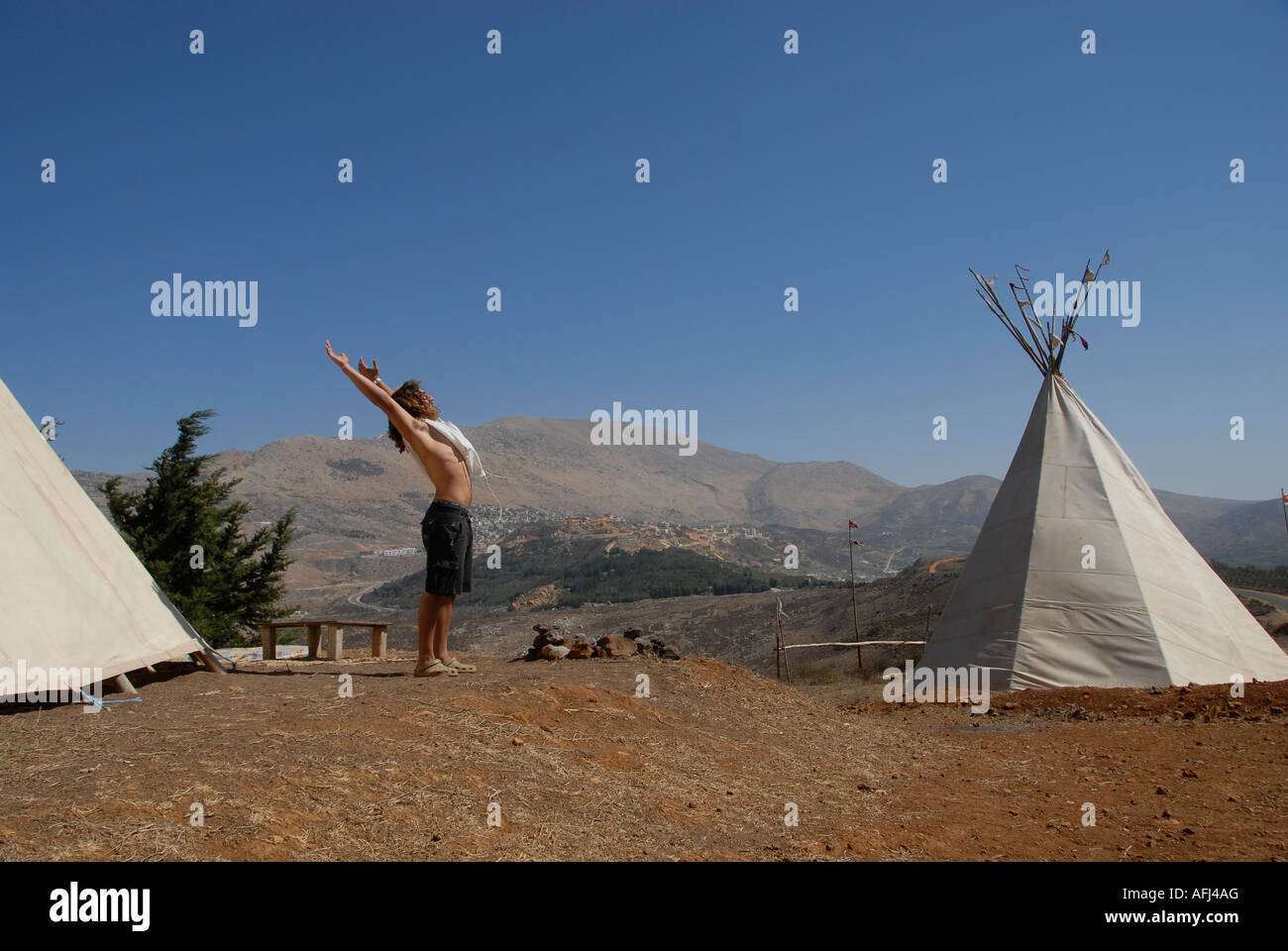 An Israeli young man stretches in a Tipi tent camping compound in the ...