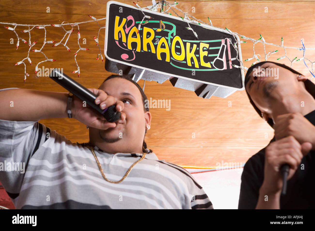Young men singing at local bar Stock Photo - Alamy