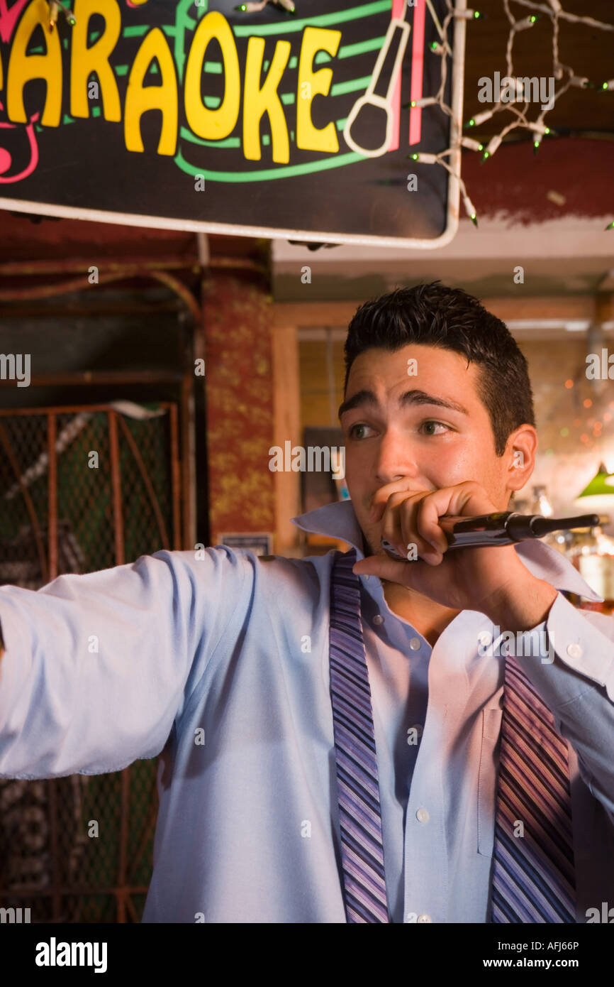 Young businessman singing at local bar Stock Photo - Alamy