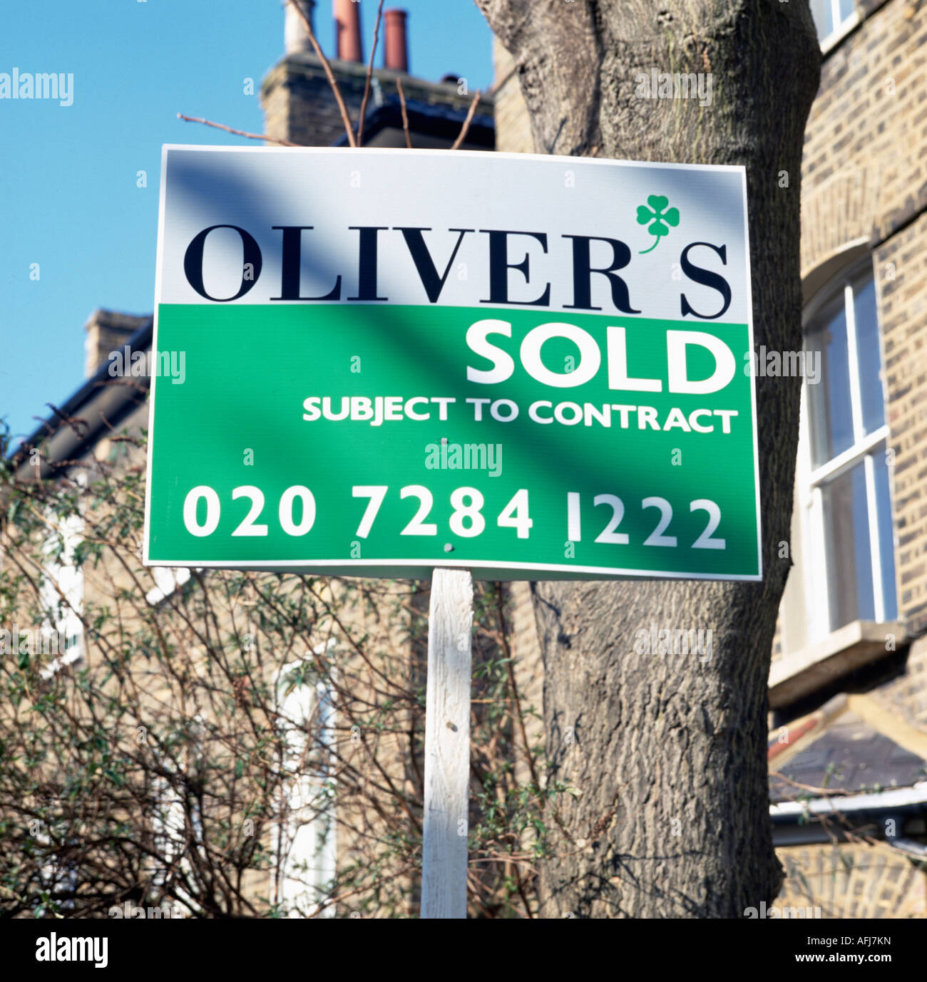 Estate Agents Sold sign board outside house Stock Photo - Alamy