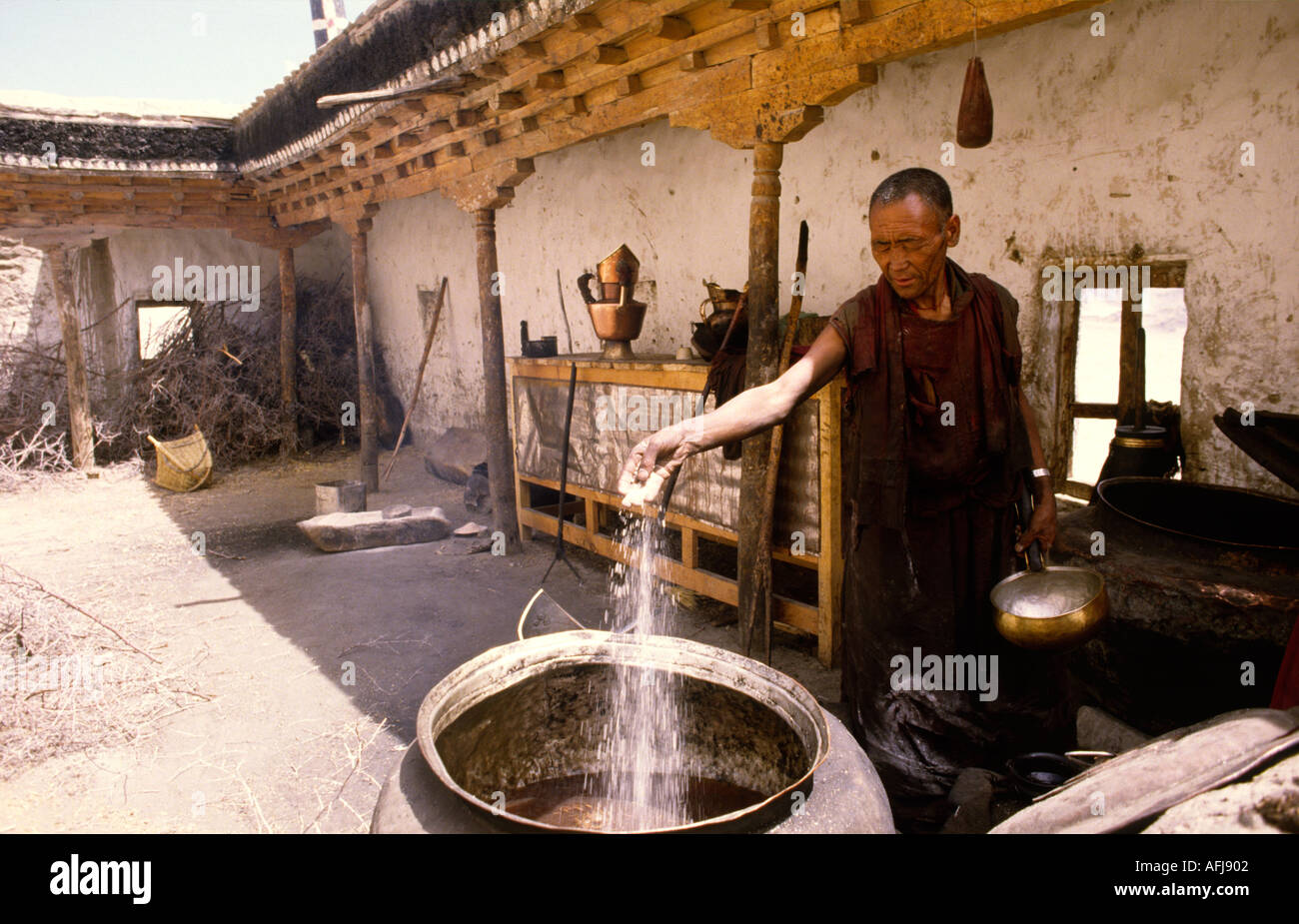 Buddhist monk pouring ingredients into urn Tikshey monastery Ladakh ...